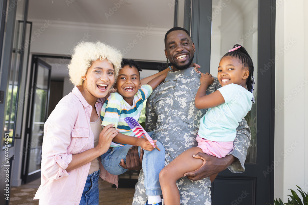 African American soldier in military uniform with his family outside ...