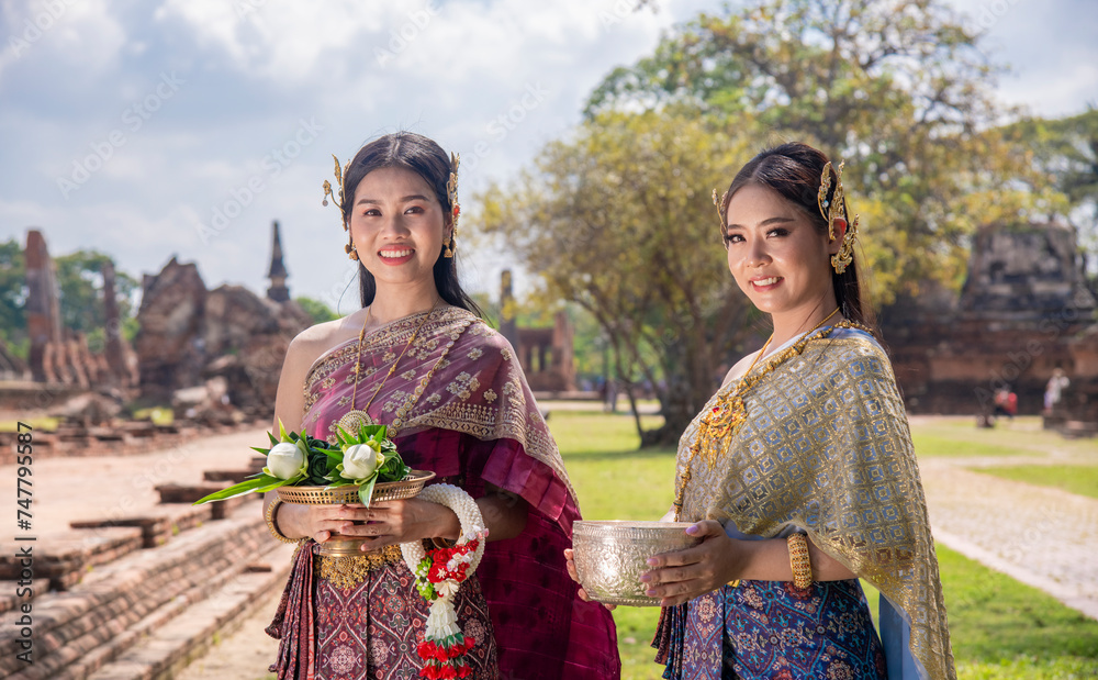 Asian woman wearing ancient Thai traditional dress holds garland and ...