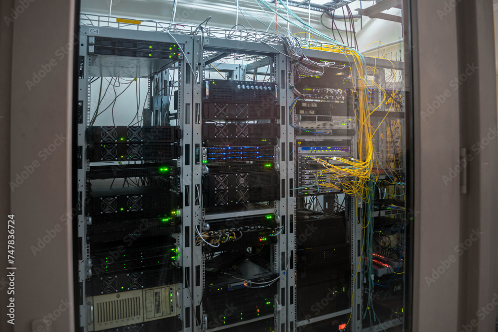 Powerful computer equipment works behind the glass door of a server ...