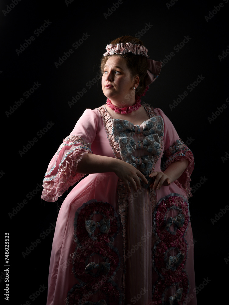 close upProfile portrait of female model wearing an opulent pink gown ...