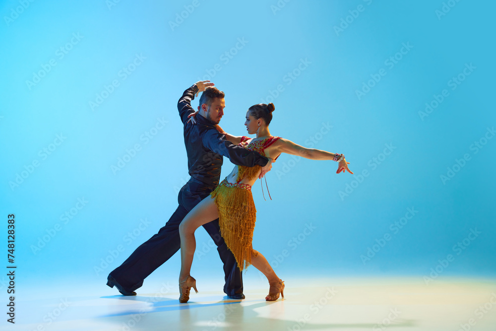 Two male and female dancers in a Latin ballroom stance, dancing against ...