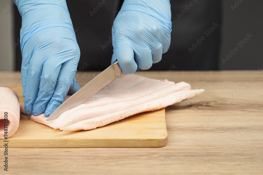 Fat is cut into small pieces. Hands of a cook cutting lard with a knife ...