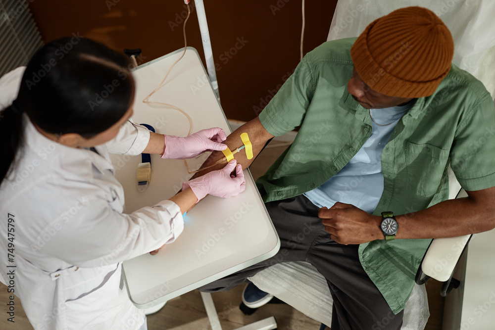 Top view portrait of female doctor preparing patient for IV infusion in ...