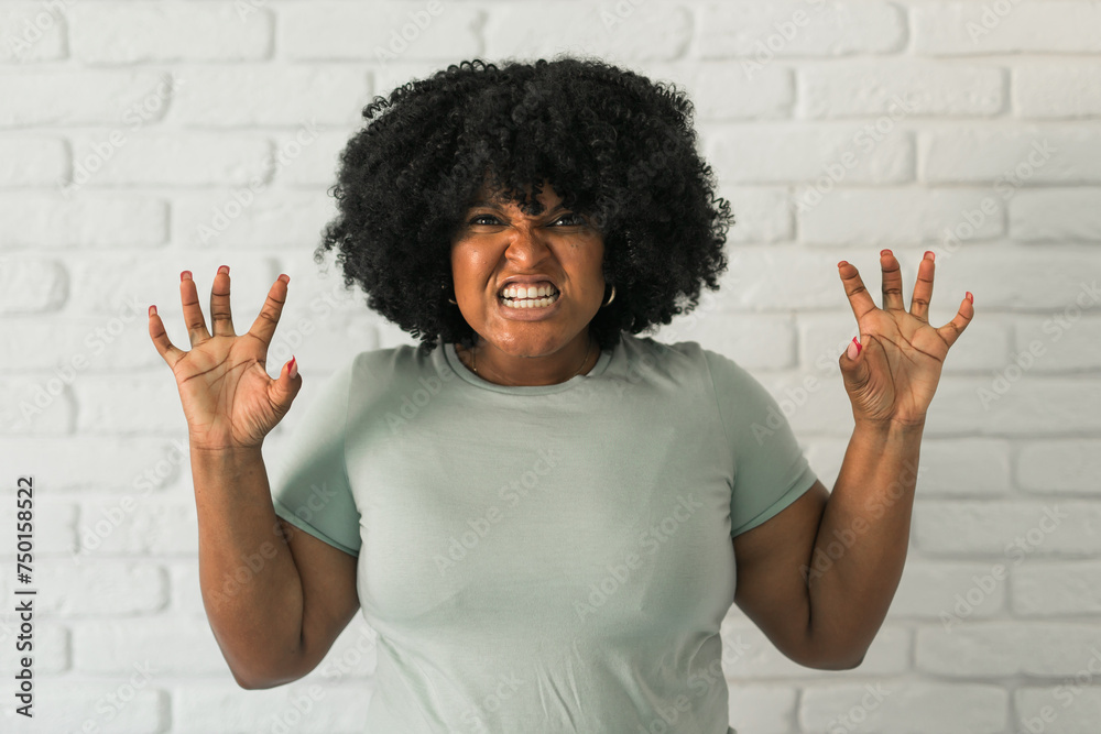 Angry african american woman screaming on brick background. Bad ...