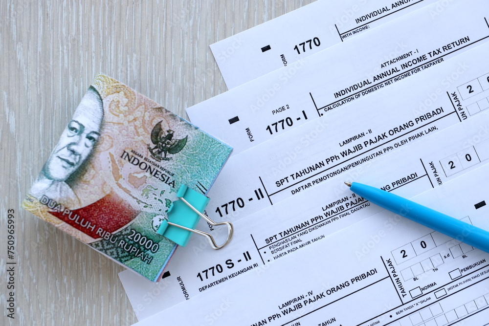 Annual Individual Income Tax Return forms with pen and indonesian ...