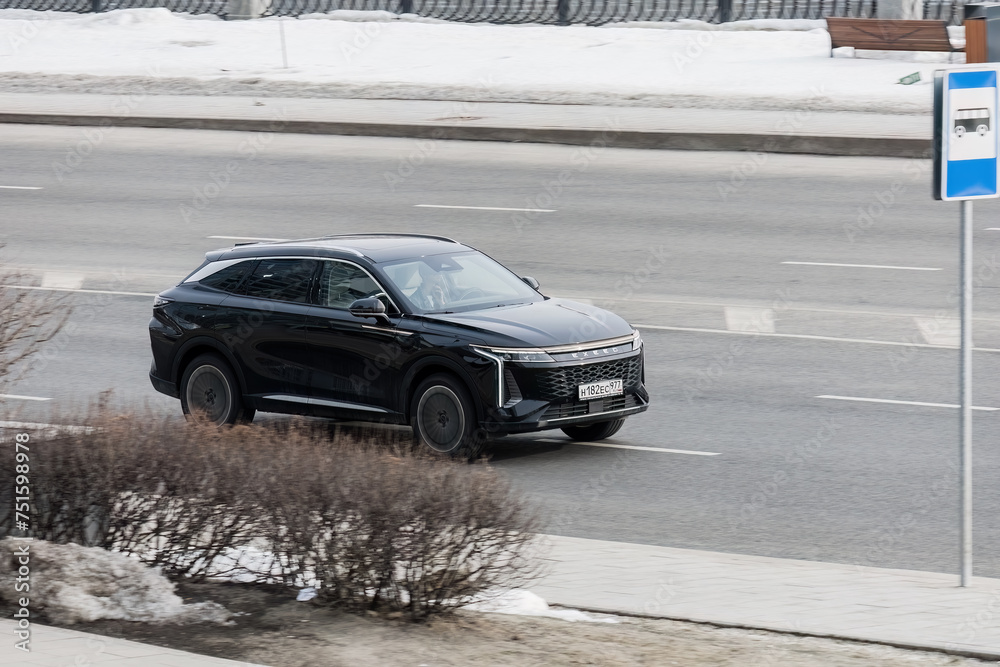 Front side view of black crossover Exeed RX in motion. Exeed Yaoguang ...