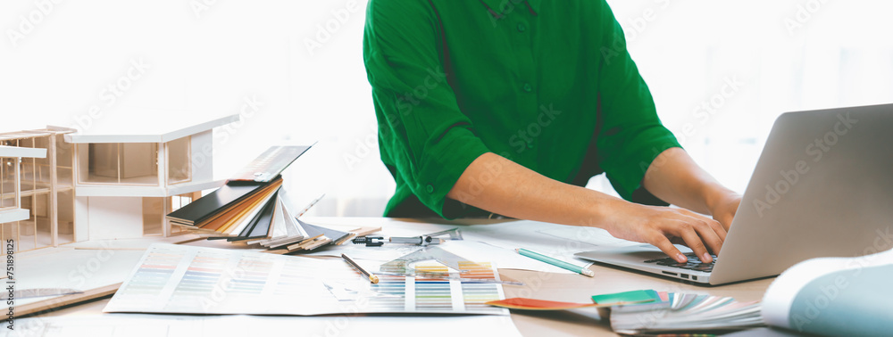 Cropped image of professional interior designer using laptop to create ...