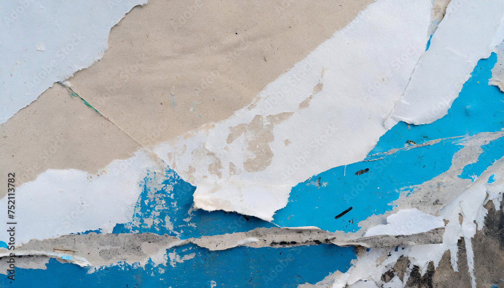 Textured wall with peeling paint and torn paper layers, revealing a mix ...