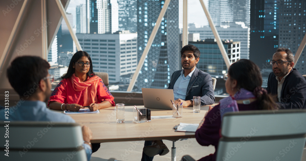 Young Indian Businessman Leading a Conversation with a Talented Team of ...