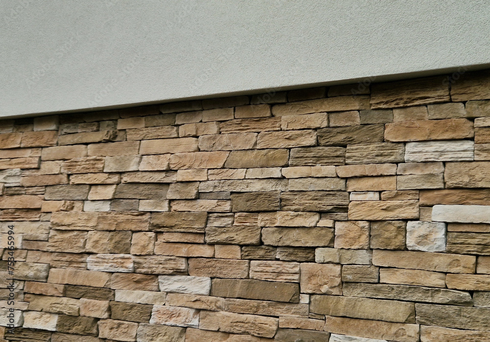Modern gray brown, beige, metal door at the house lined with stone ...