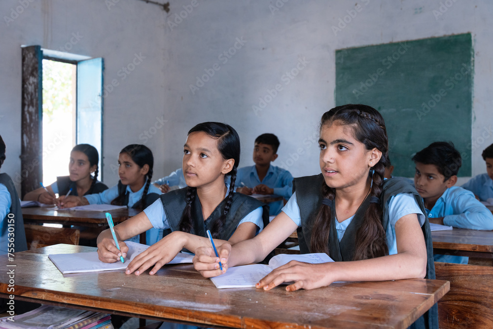 Group of indian village students in school uniform sitting in classroom ...