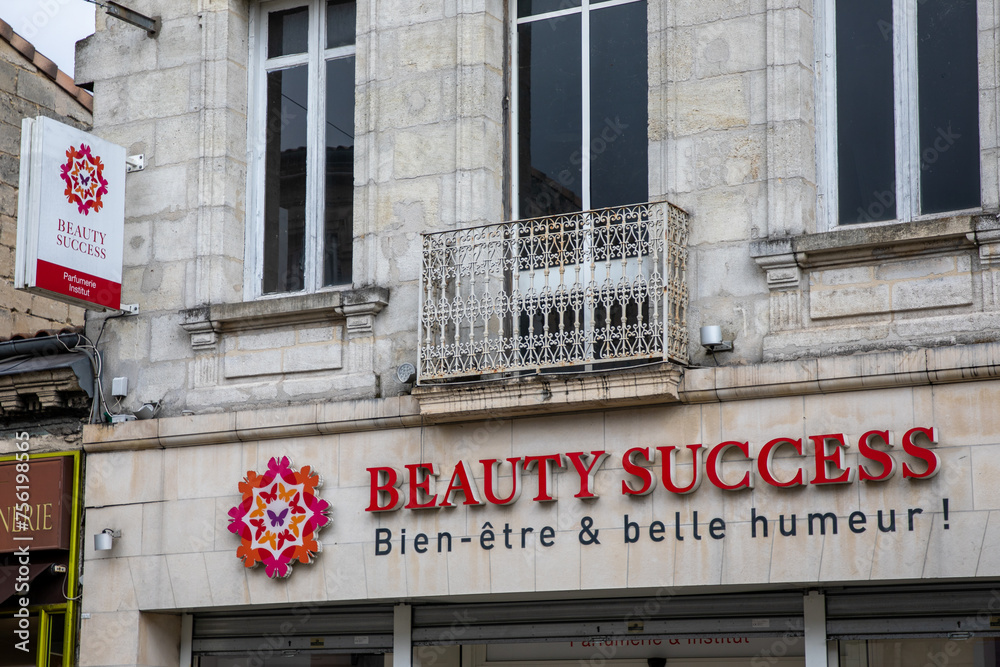 Beauty Success logo store brand and text sign shop on wall facade ...