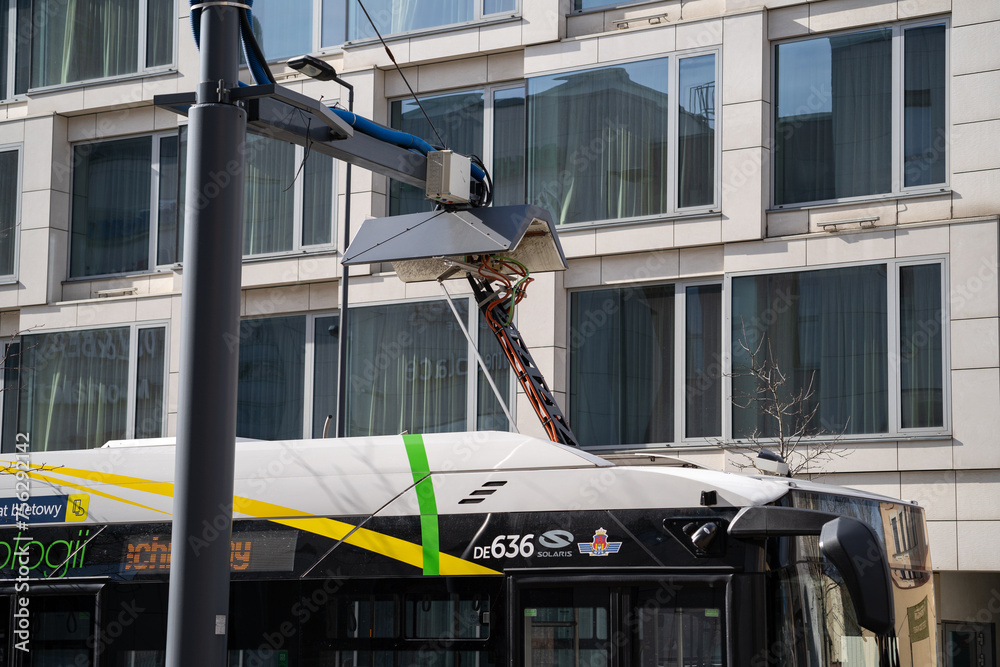 Electric city bus at pantograph charging station. EV public transport ...