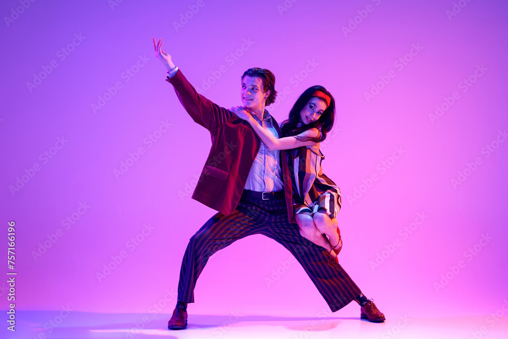 Artistic young man and woman in retro style clothes dancing boogie ...