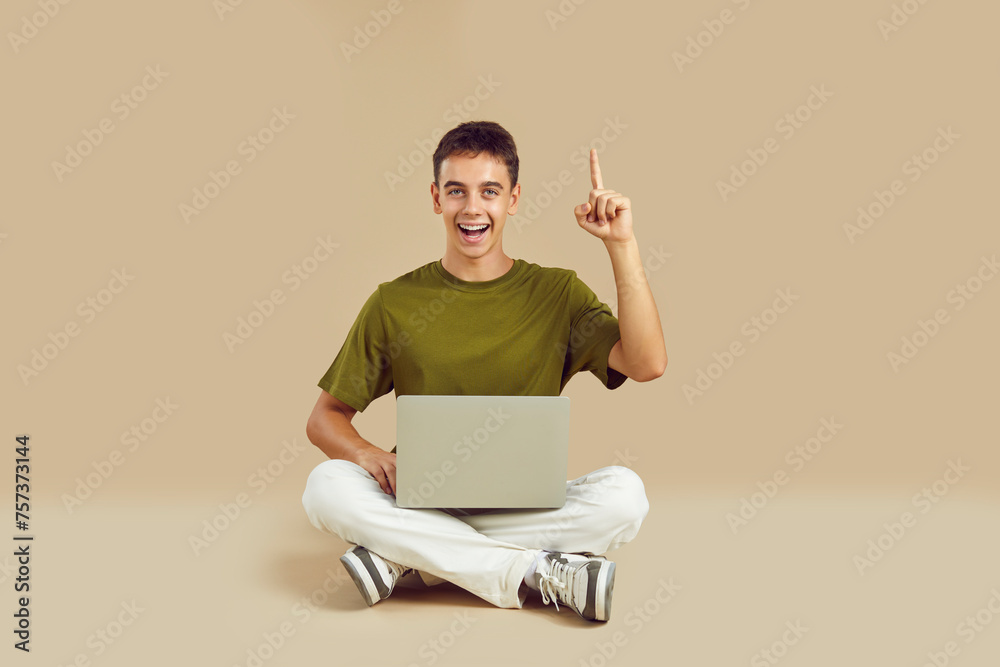 Portrait happy clever adolescent high school student boy with laptop ...