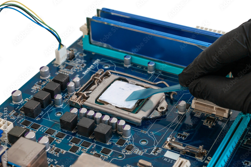 Engineer applies thermal paste to a processor installed in a socket on ...