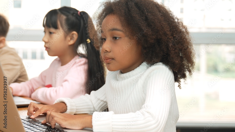 African girl play laptop with diverse friend learning prompt at STEM technology class ...