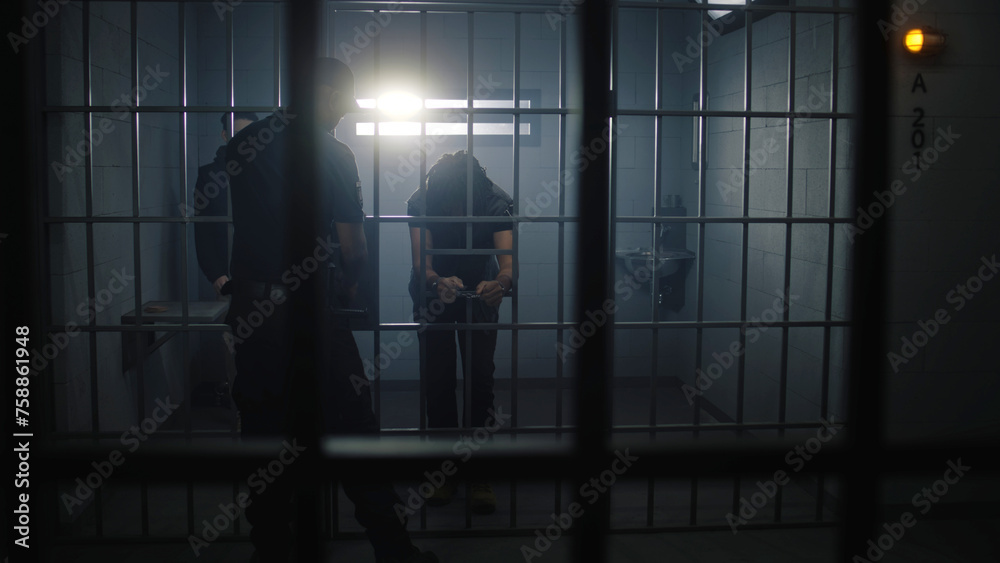 Warden brings new prisoner in jail cell and takes off his handcuffs ...