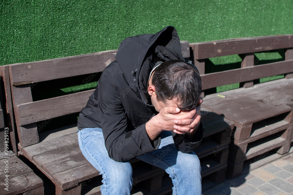 Sad man sitting on the bench Stock Photo | Adobe Stock