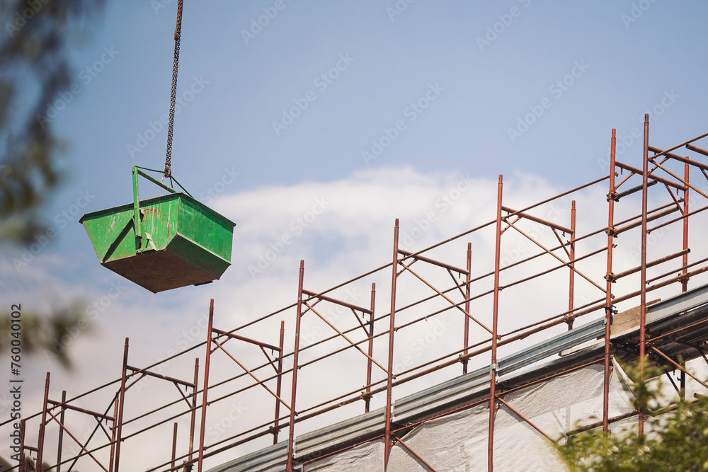 crane bucket concrete work construction. Green builders skip lifted by ...