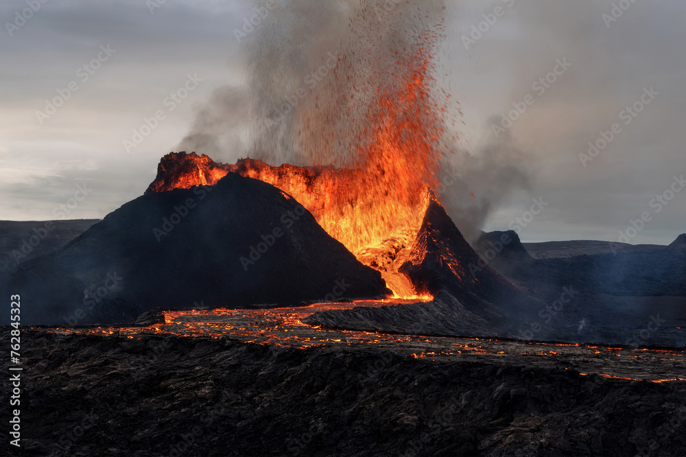 Volcanic eruption explosion and lava flow in the lava field of ...