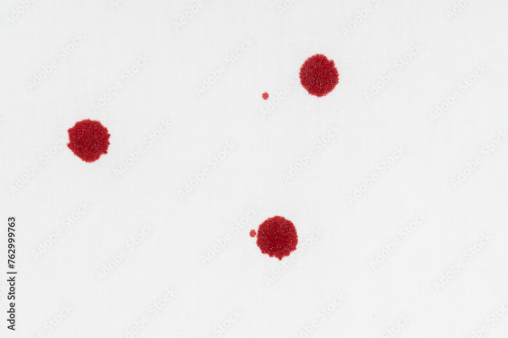 Drops of blood stains on white fabric. blood splatters on clothes. red ...