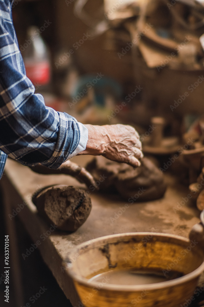 Hands molding clay in a clay workshop to teach people how to mold the ...