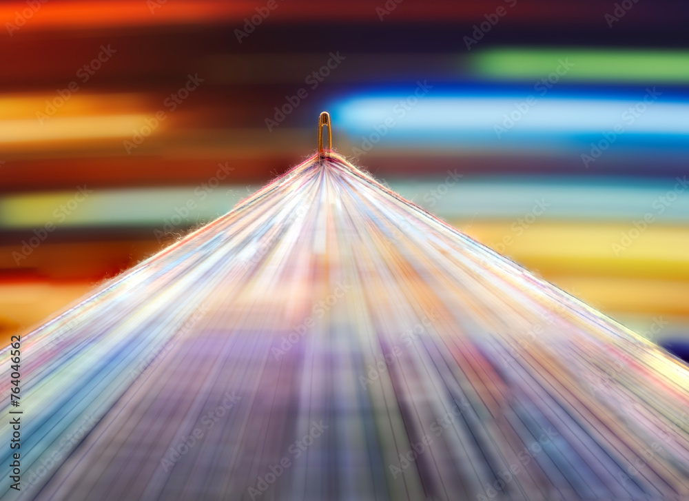 Converging Multi-colored Sewing Thread with motion blur effect on a rotating table, colorful ...