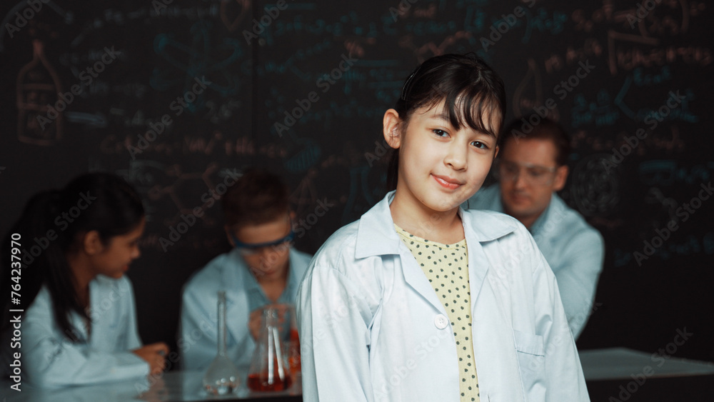 Cute asian scientist smile to camera while diverse group doing ...