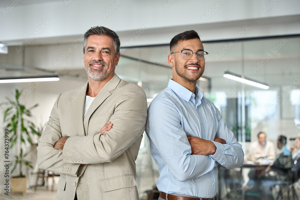 Two smiling confident business men leaders, happy corporate managers, young and middle aged ...