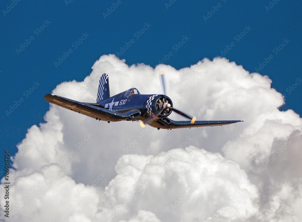 Vought F4U Corsair Fighter in Flight with Puffy White Clouds Stock ...