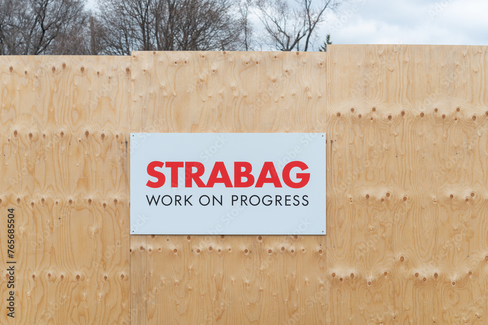 plywood hoarding and sign of STRABAG, an international company ...