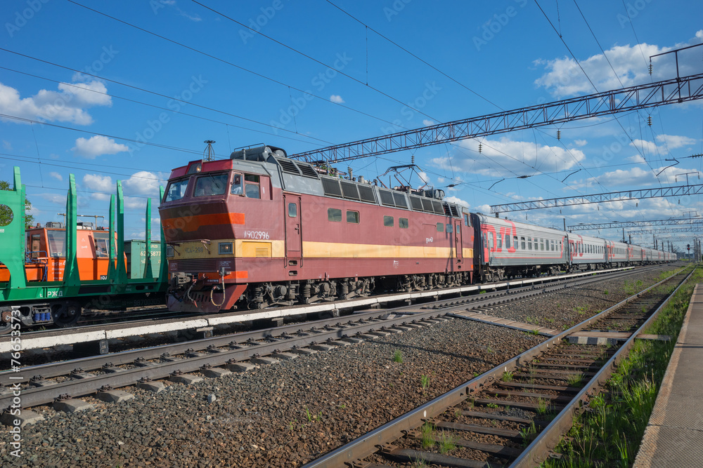 train travels by rail on a sunny day, the train with the logo of RZD ...