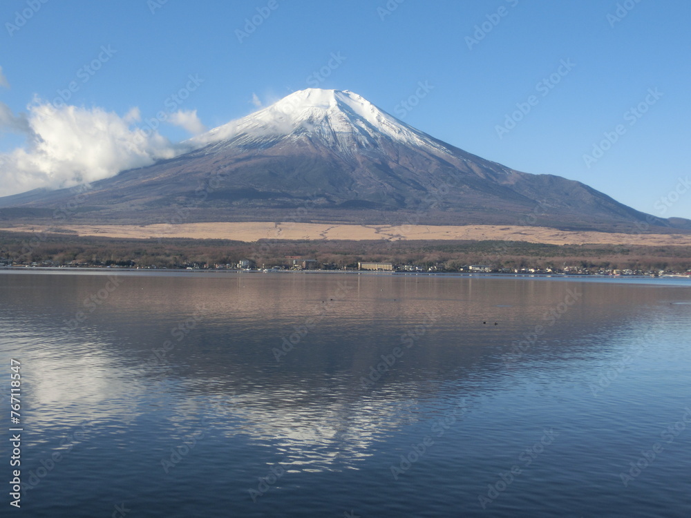 Amidst the tranquility, the presence of Fuji-san loomed large, its reflection serving as a ...
