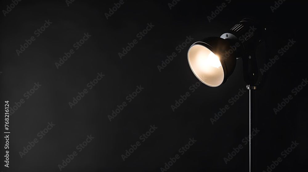 Black background with a single spotlight. The spotlight is turned on ...