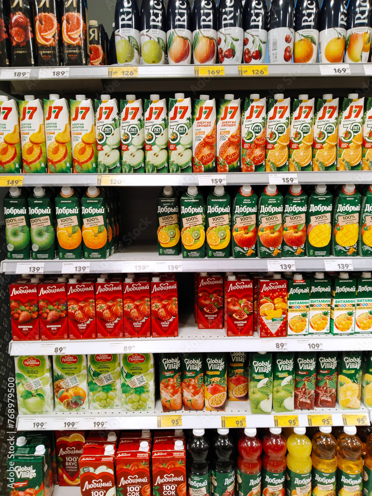 Supermarket shelves with various packs of fruit juice: J7, Rich, Kind ...
