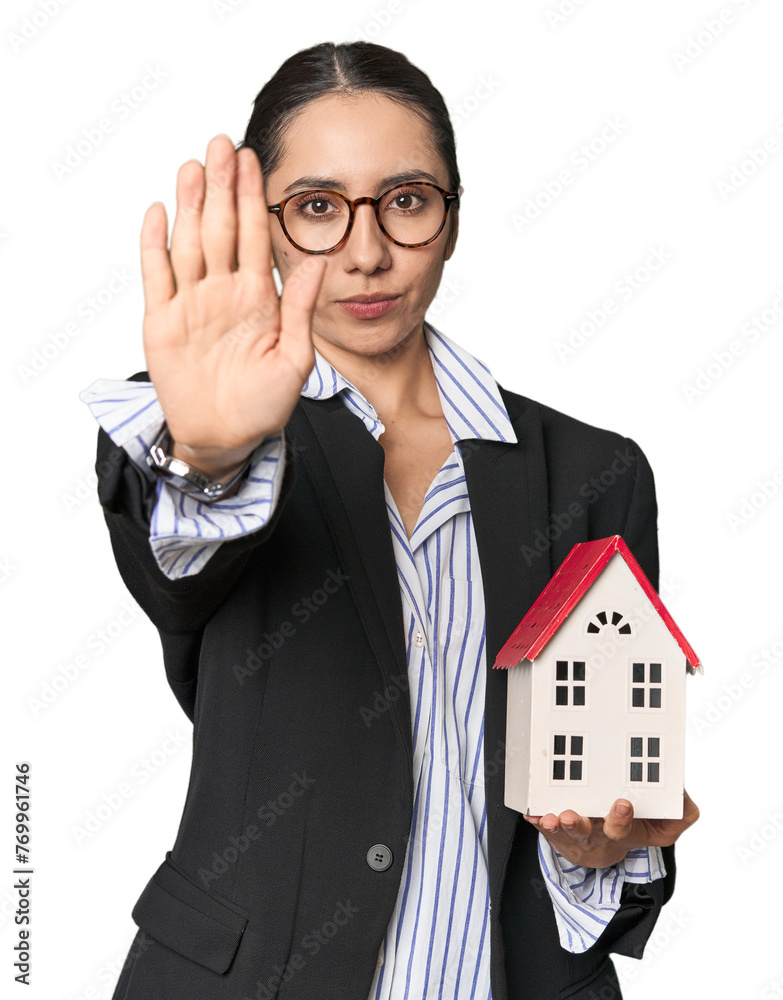 Caucasian businesswoman with house model, real estate concept on studio ...