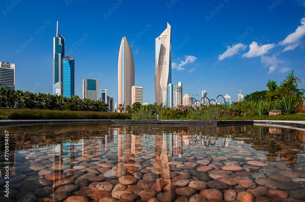 the Al Hamra Tower in Kuwait City photographed from an urban park with ...