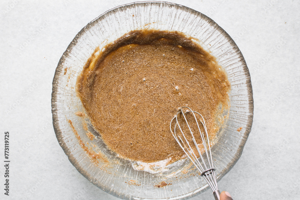 Creaming butter brown sugar and egg with a whisk, the process of making ...