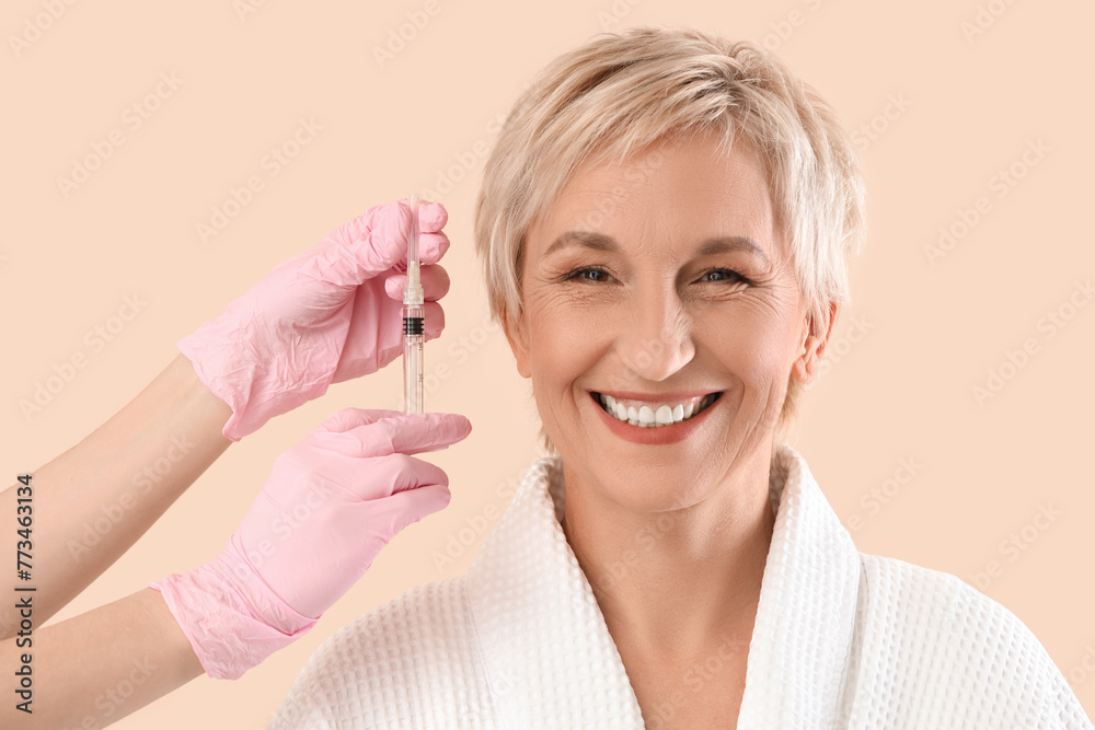 Beautiful mature woman receiving injection on pink background, closeup ...