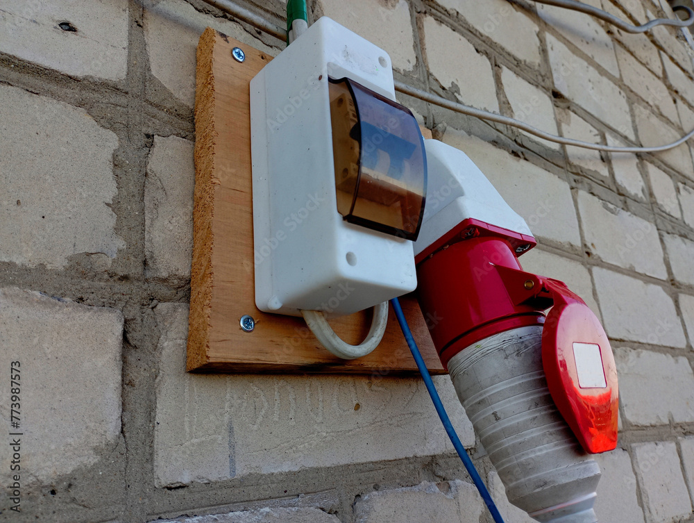 Stock-Foto „Self-made car charging on the wall of a brick house ...