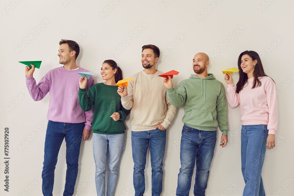 Group of coworkers with teamwork and camaraderie, holding paper ...