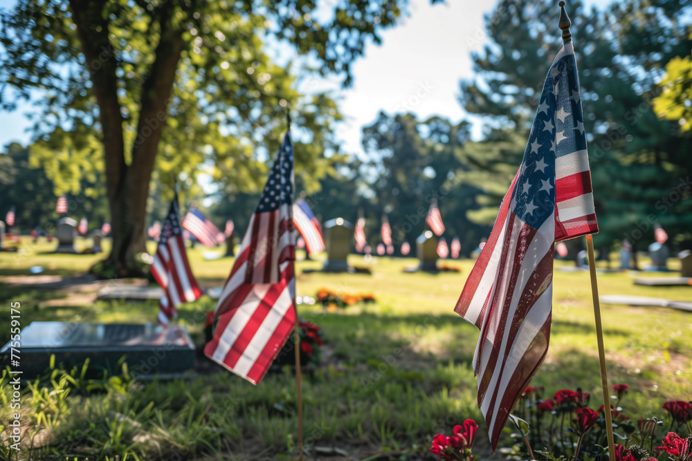 A cemetery with four American flags in the grass. The flags are in ...
