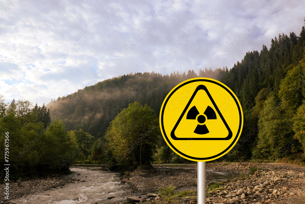 Radioactive pollution. Yellow warning sign with hazard symbol in ...