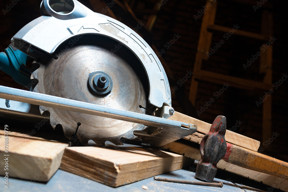 Circular saw, construction tools and wooden boards close up background ...