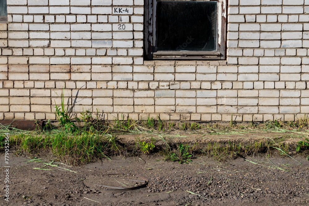 background consisting of a brick building with an old blind area window ...