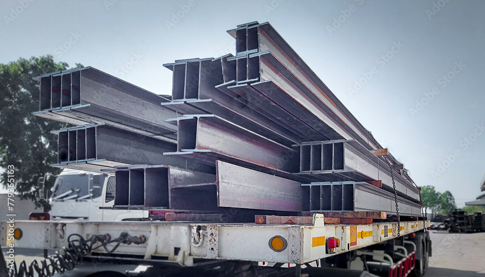 Trucks with long trailers carrying steel bars for building construction ...