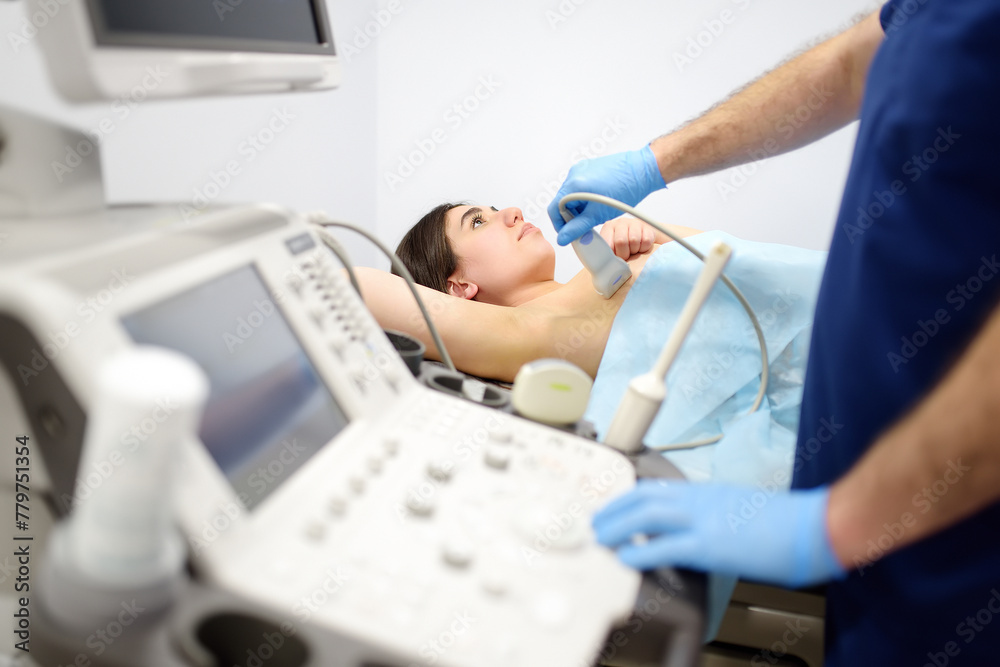 Mammologist doctor examines a woman breasts and lymph nodes using ...