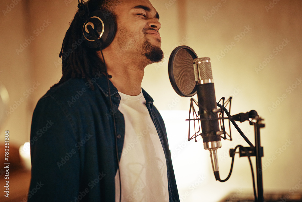 Young black charismatic singer with dreadlocks, passionately singing ...