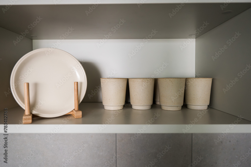 Beige vertical striped ceramic cups with uneven coating and no handles ...